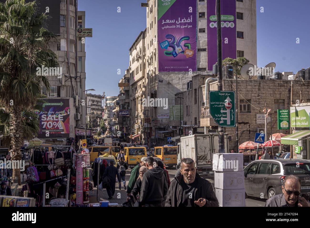 The street, traffic, buildings, and Palestinian people in the downtown ...