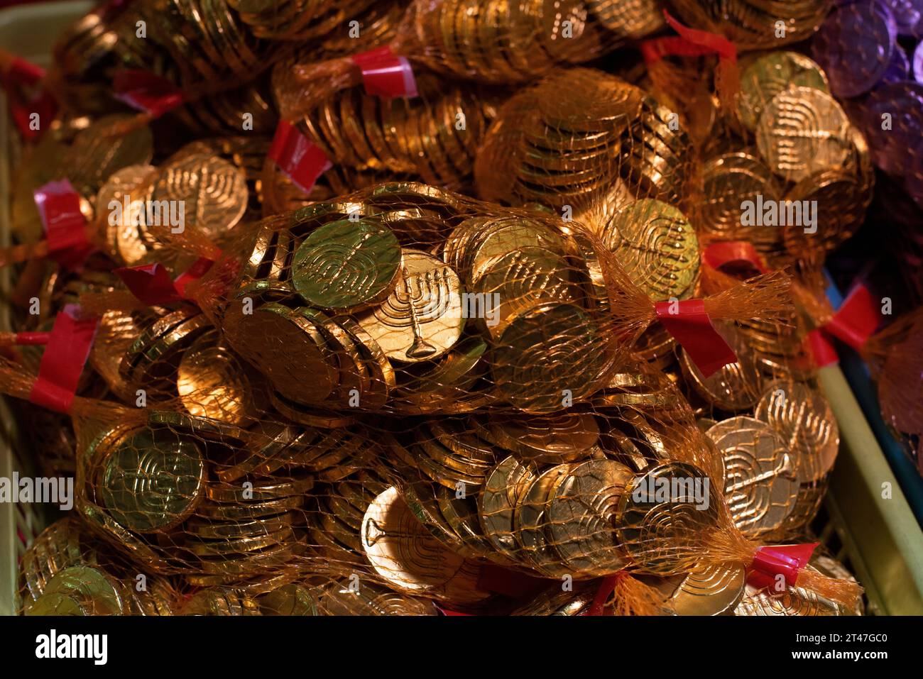 Gold and silver foil wrapped traditional chocolate coins in small net ...