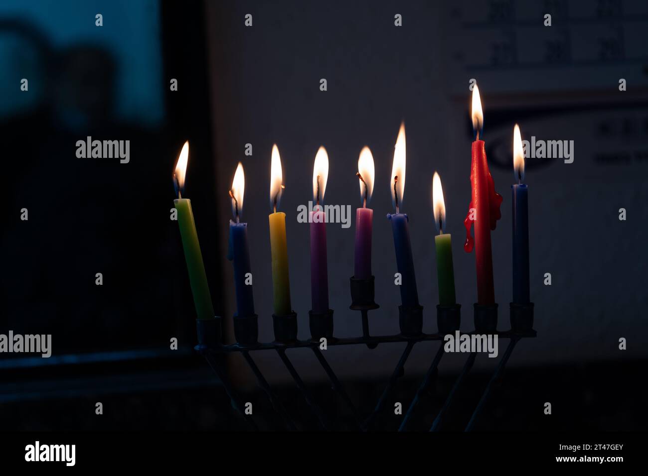 Multi Colored Wax Hanukkah Candles Burn In A Menorah During