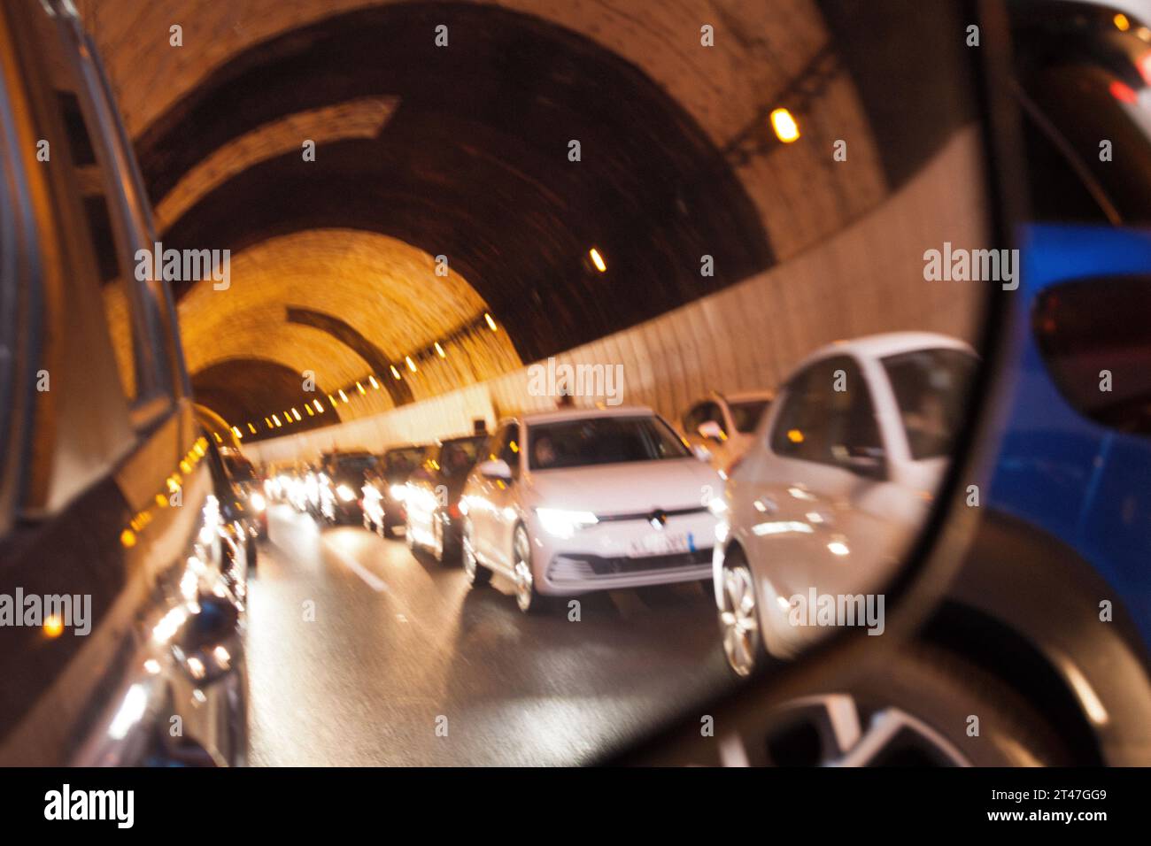 image taken from a car mirror during a traffic jam inside a tunnel ...