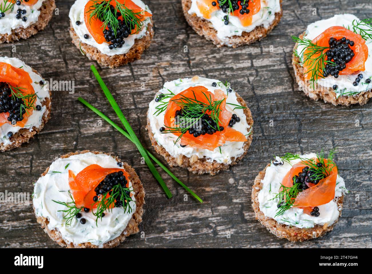 Cocktail canapes with smoked salmon, cream cheese and caviar on rye ...