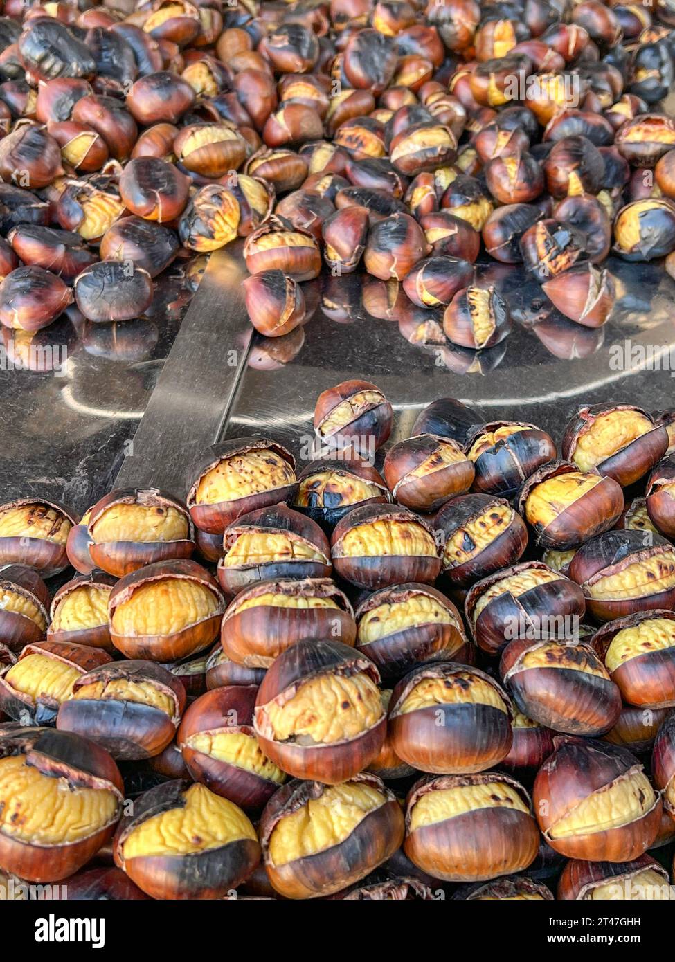 chestnuts, heap of roasted chestnuts with selective focus on street ...