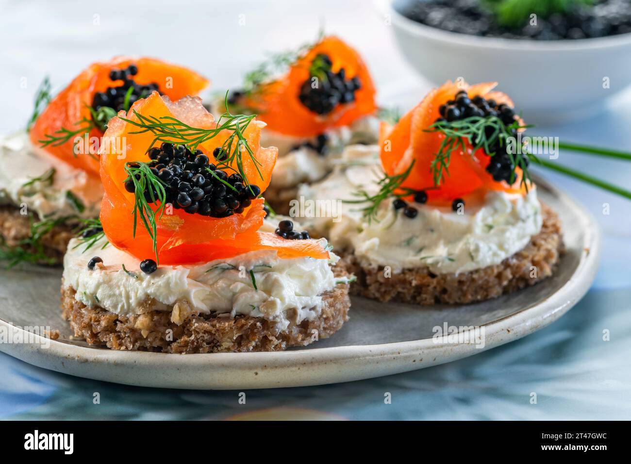 Cocktail canapes with smoked salmon, cream cheese and caviar on rye ...