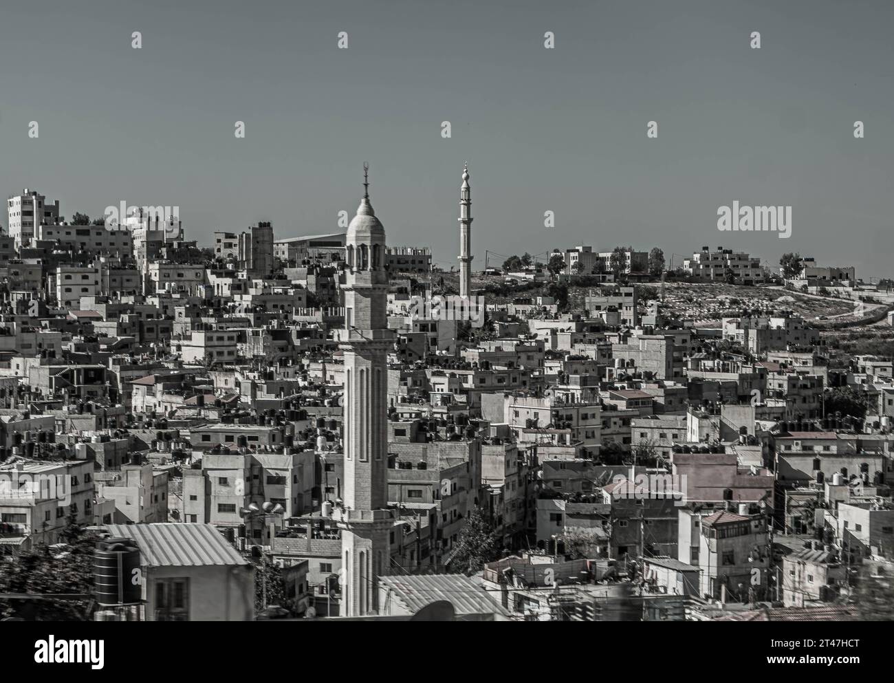The cityscape, buildings, roofs, and mosque minarets, at Ramallah, the ...