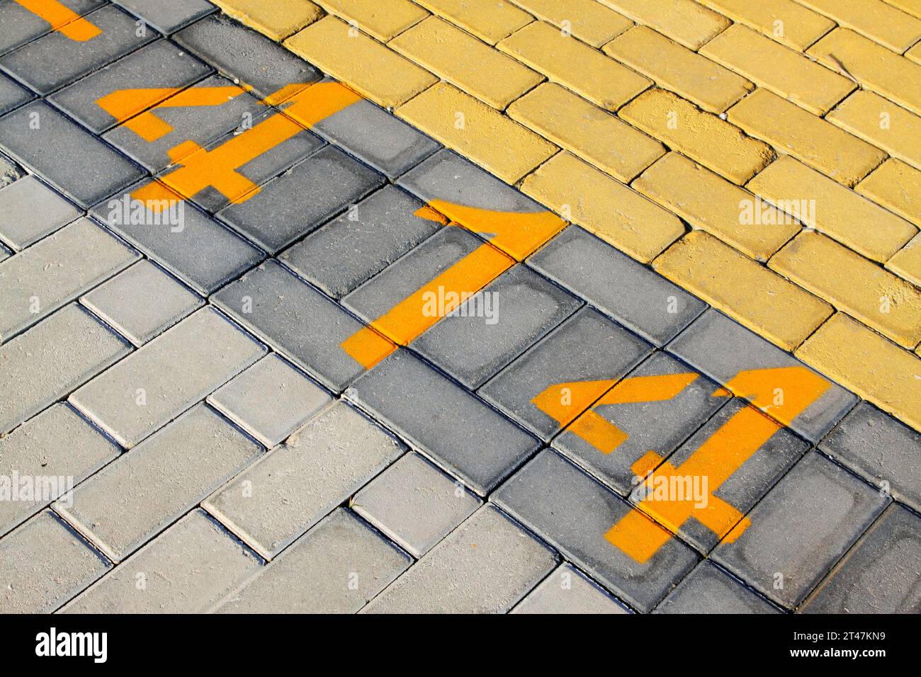 yellow numbers on color cement block, closeup of photo Stock Photo - Alamy
