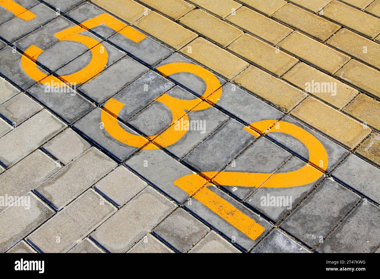 yellow numbers on color cement block, closeup of photo Stock Photo - Alamy