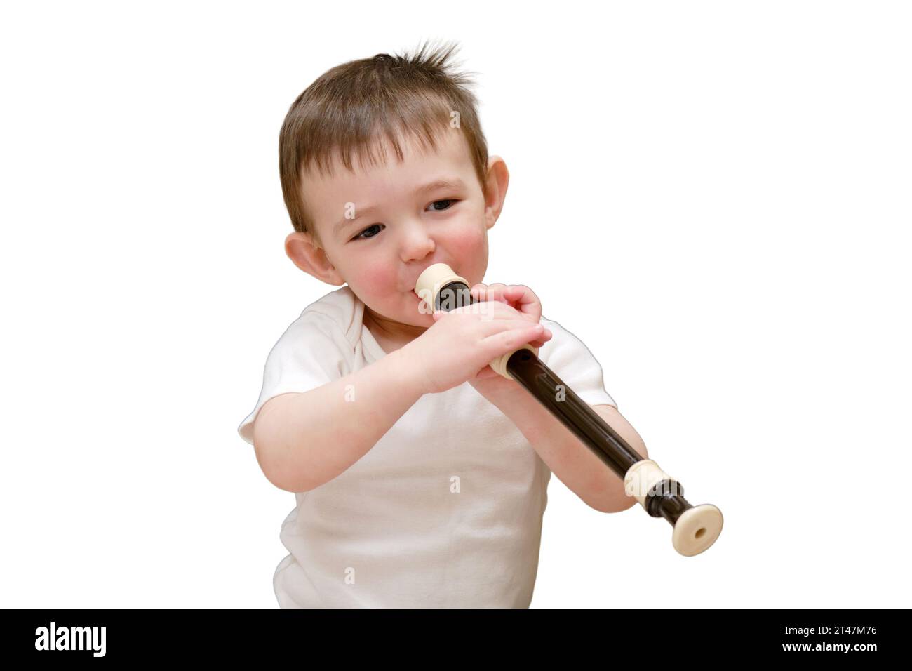 Toddler baby plays the flute sitting on the floor in the children's ...