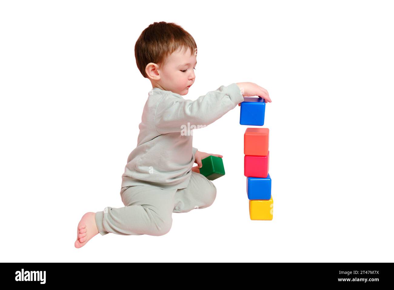 Happy toddler baby plays with cubes on studio, isolated on white ...