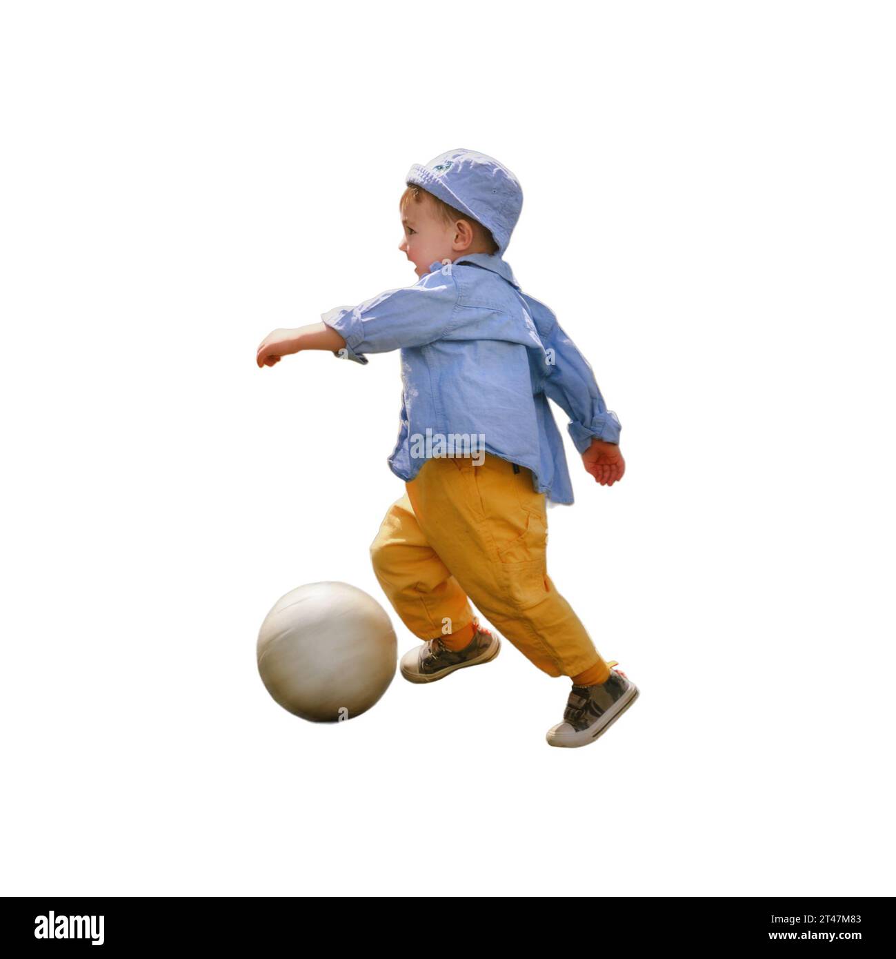 The child is trying to score a goal with the yellow ball on the soccer ...