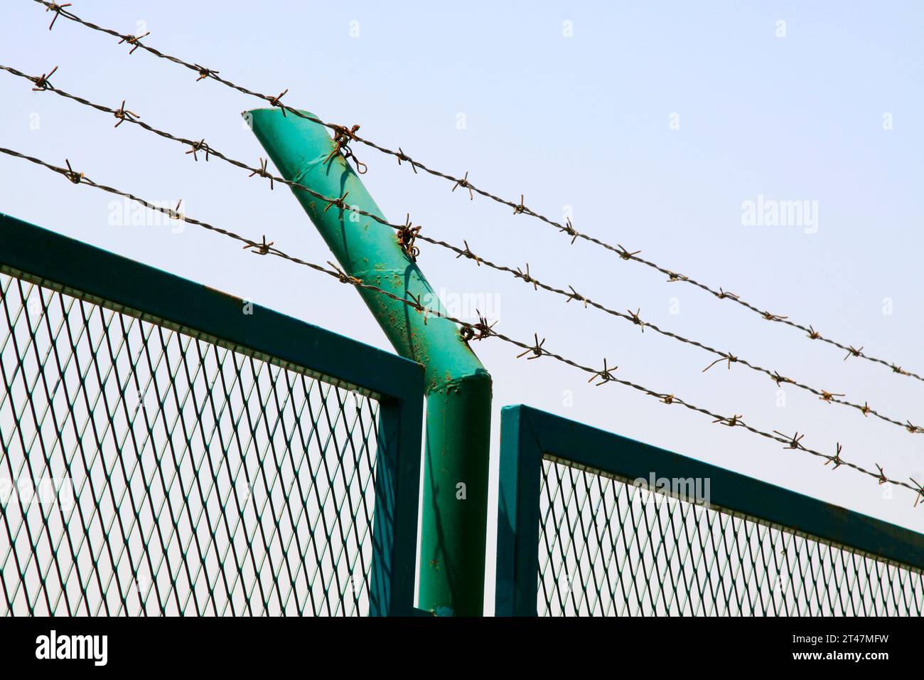 metal barriers and barbed wire, closeup of photo Stock Photo - Alamy