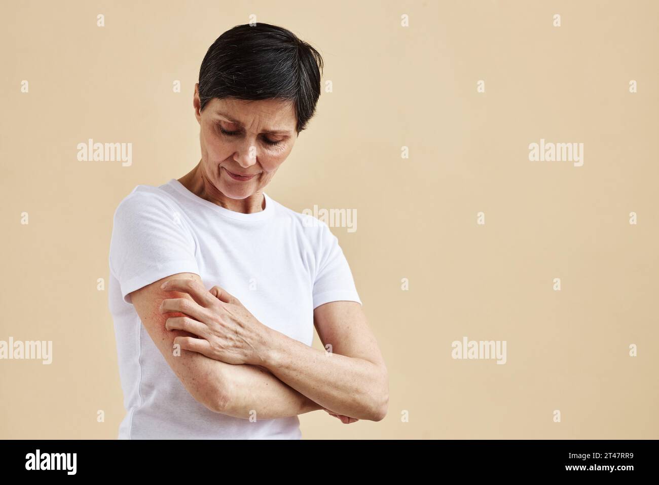Minimal waist up portrait of adult woman scratching skin standing ...