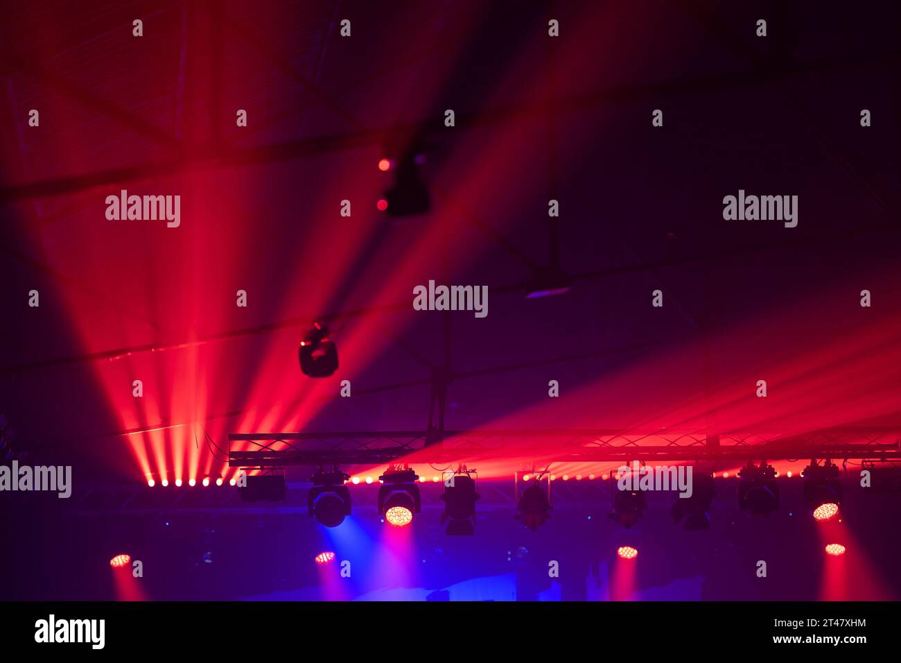 Red-lit venue with beams - concert lighting Stock Photo - Alamy