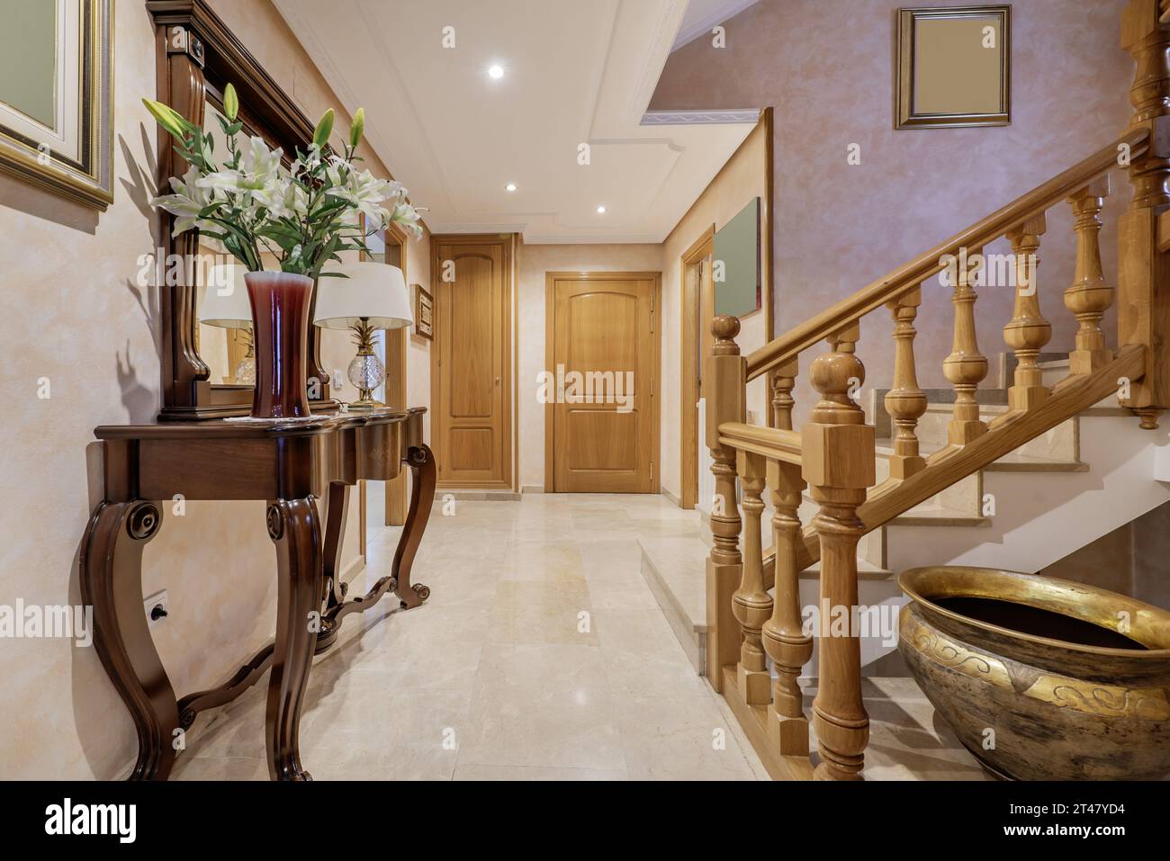 Hallway of a multi-story single-family home with light oak wood railing ...