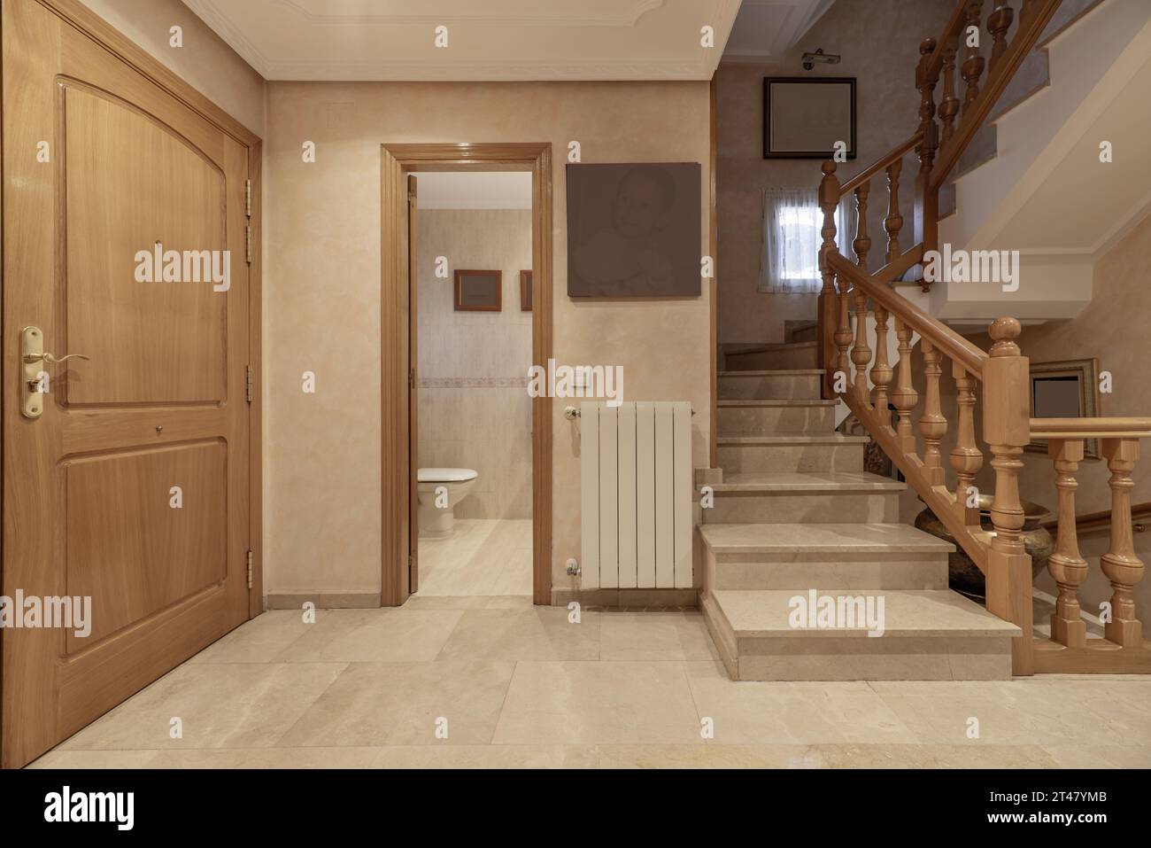 Corridor of a multi-storey detached house with light oak wood railings ...