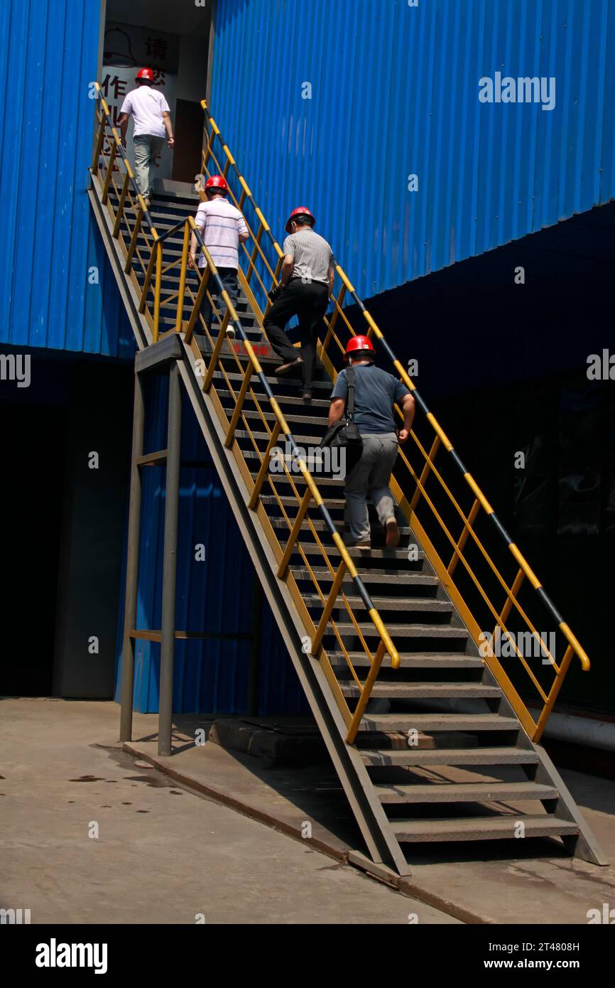 people climbing the stairs in factory Stock Photo - Alamy