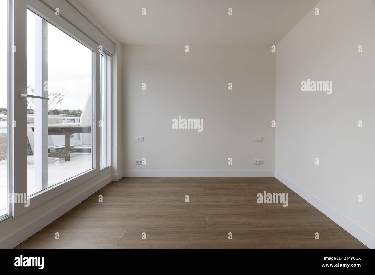 Panoramic view of a living room with wooden floors and access to a ...