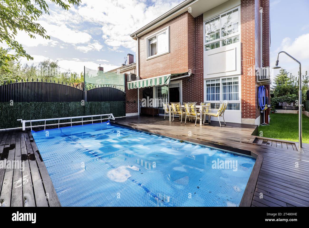 Backyard of a detached house with French windows, with swimming pool ...