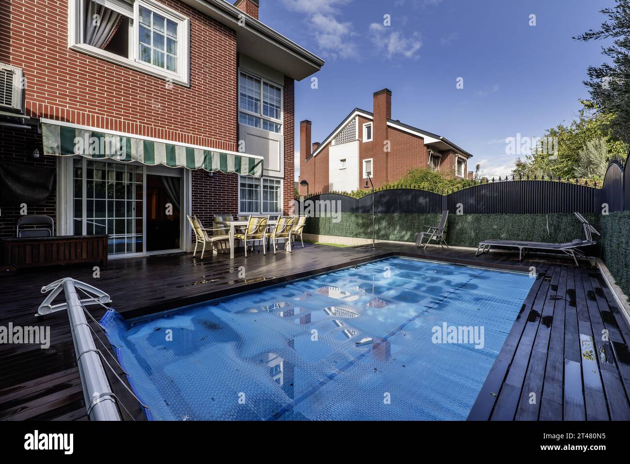 Backyard of a single-family home with swimming pool covered by a ...