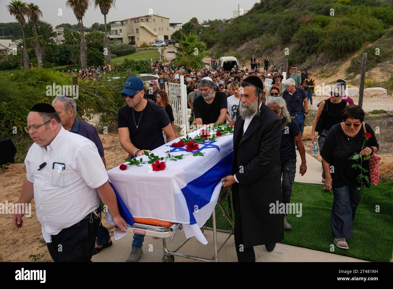 Friends and relatives of Yonat Or carry her coffin during her funeral ...