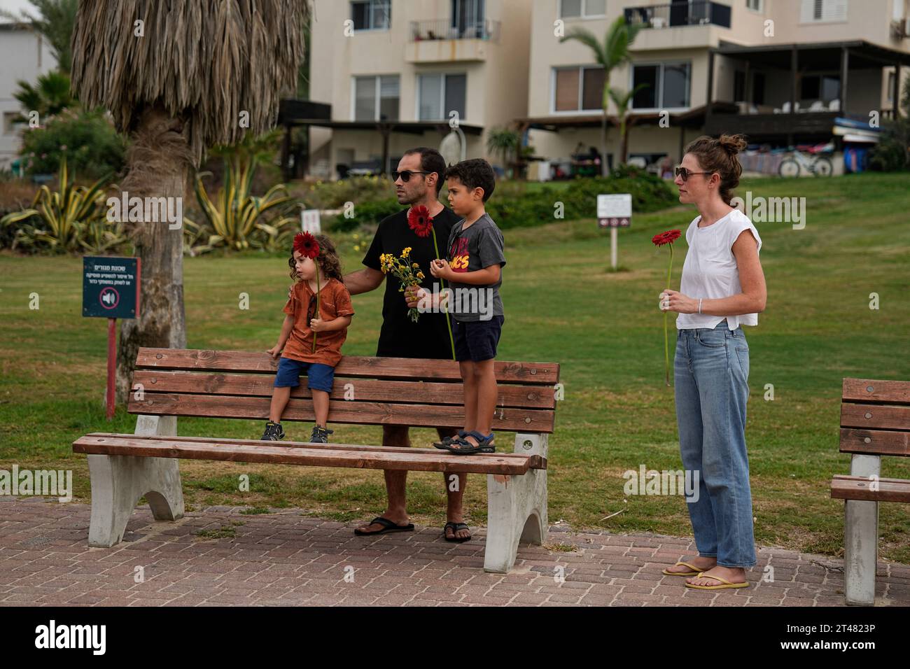 Mourners hold flowers during the funeral of Yonat Or in Kibbutz ...