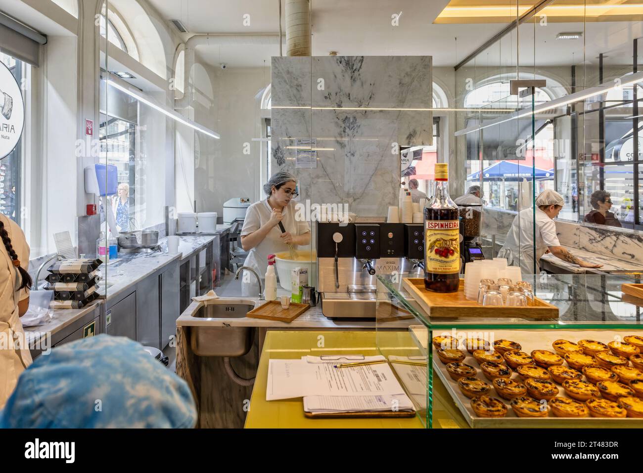 Young woman mixing ingredients to make Portuguese tarte de Natas in ...