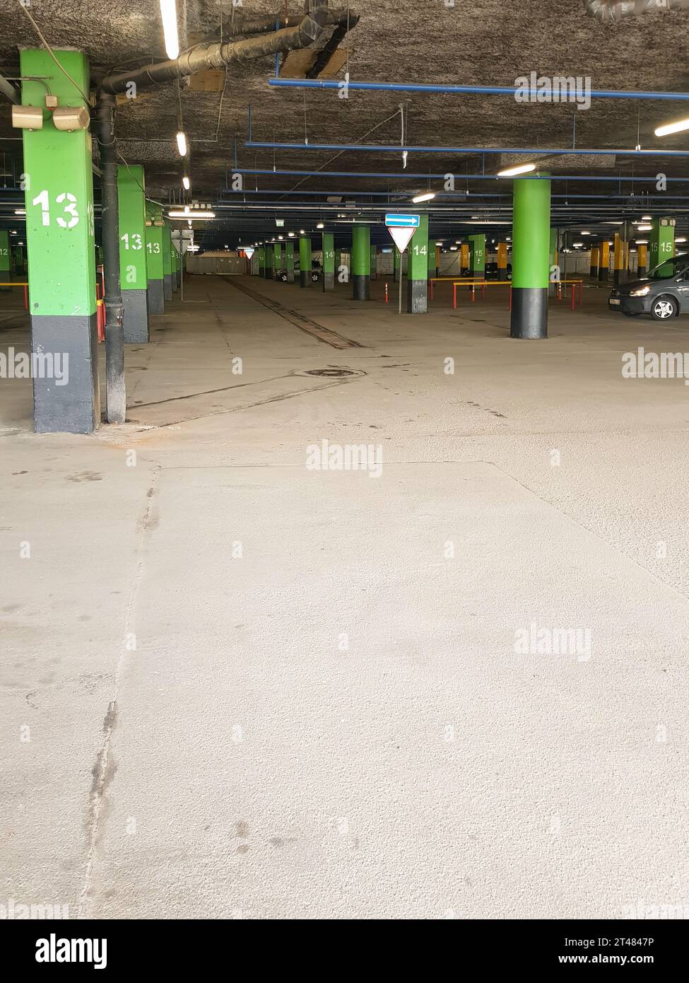 Underground Parking with poles with markings for cars in the shopping ...