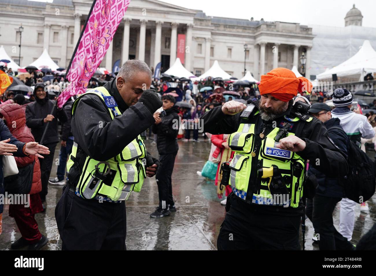 Police Officers dancing during the Diwali on the Square celebration, in ...
