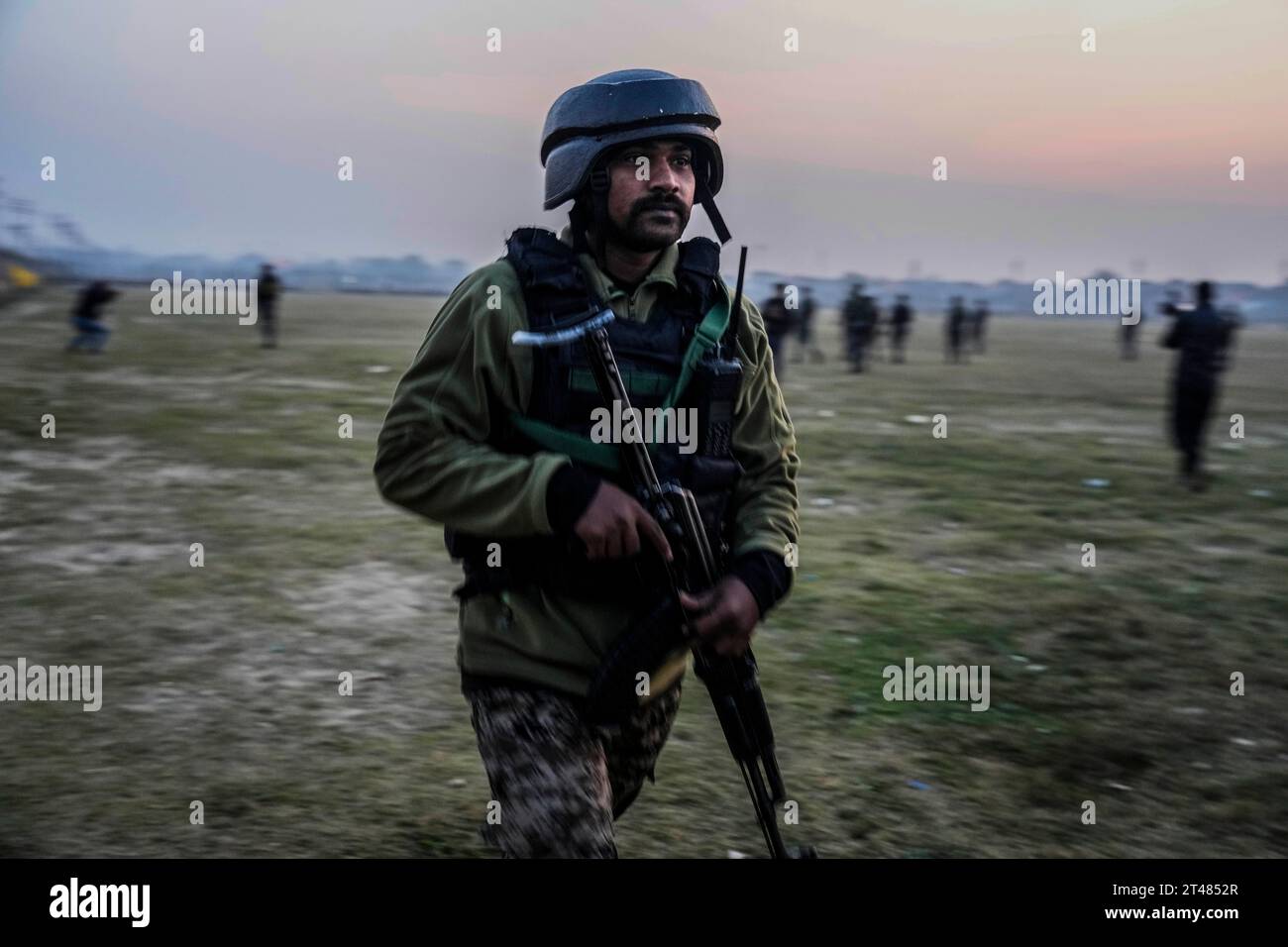 An Indian paramilitary soldier arrives at the site after suspected ...