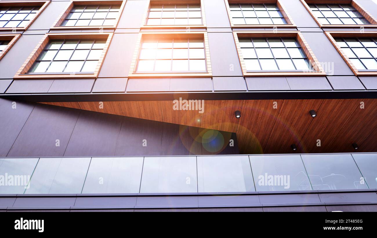A view at a straight facade of a modern building with a dark grey ...