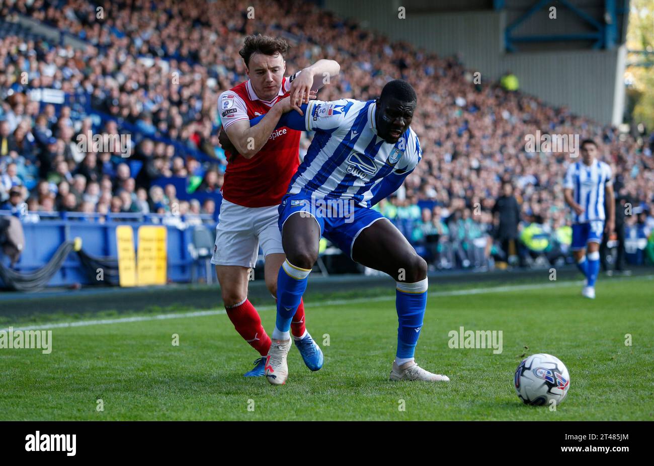 Rotherham United's Ollie Rathbone battles for the ball with Sheffield ...