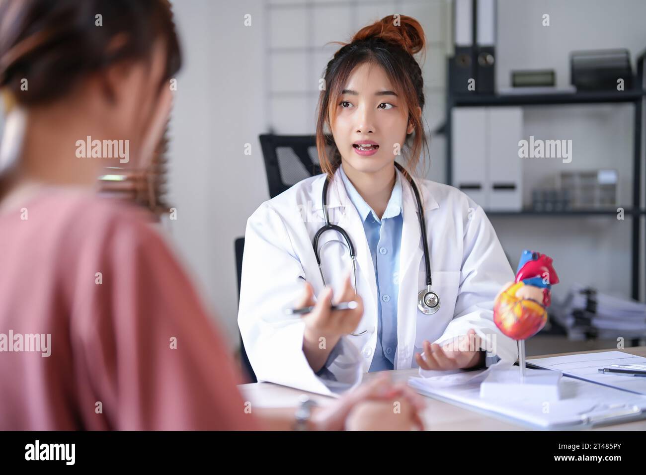 Asian cardiologist doctor women explaining about anatomical of human ...