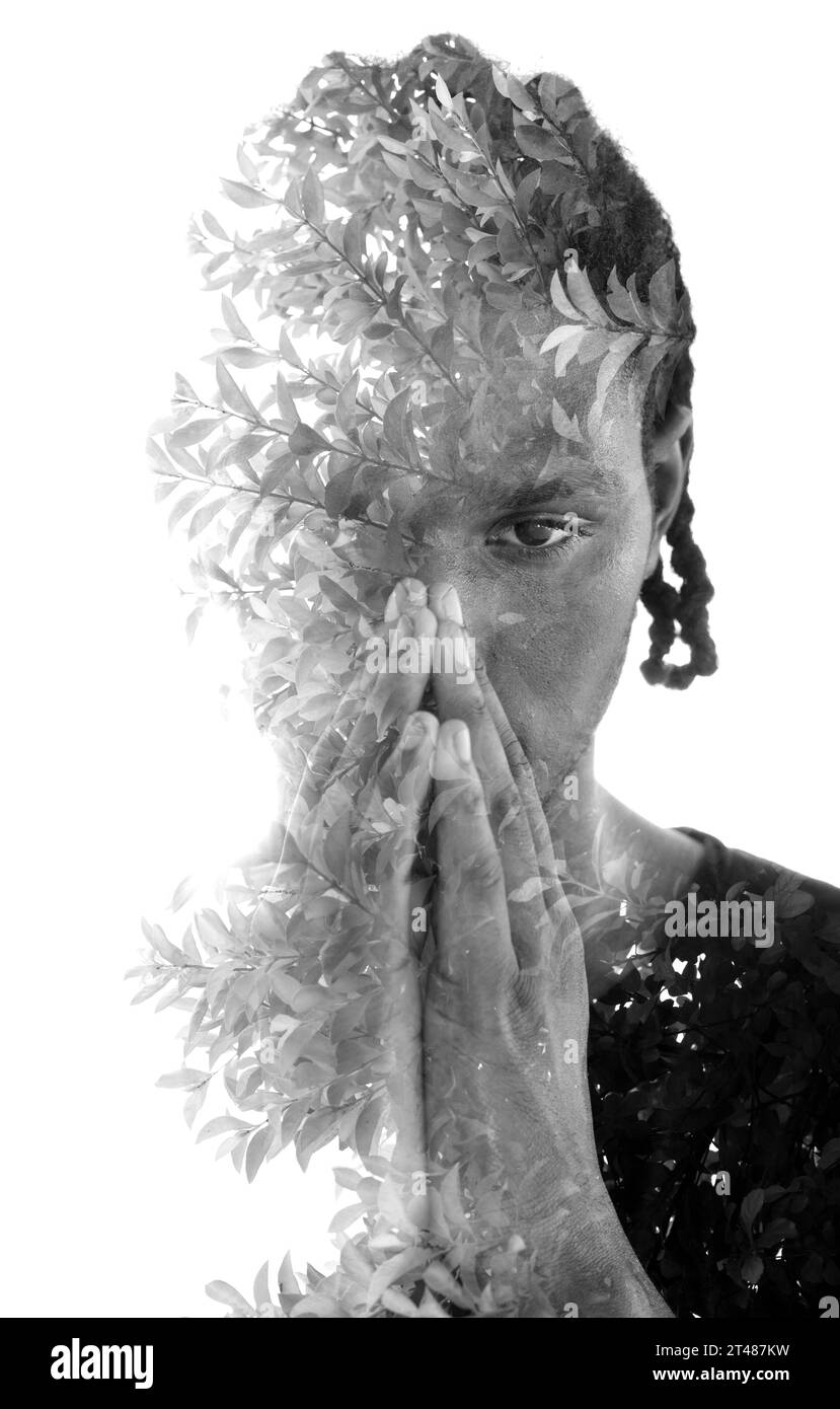 A man with palms at his face. A black and white double exposure ...