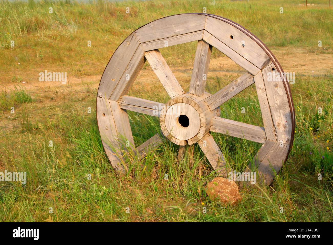Wooden wheels in the grasslands, closeup of photo Stock Photo - Alamy
