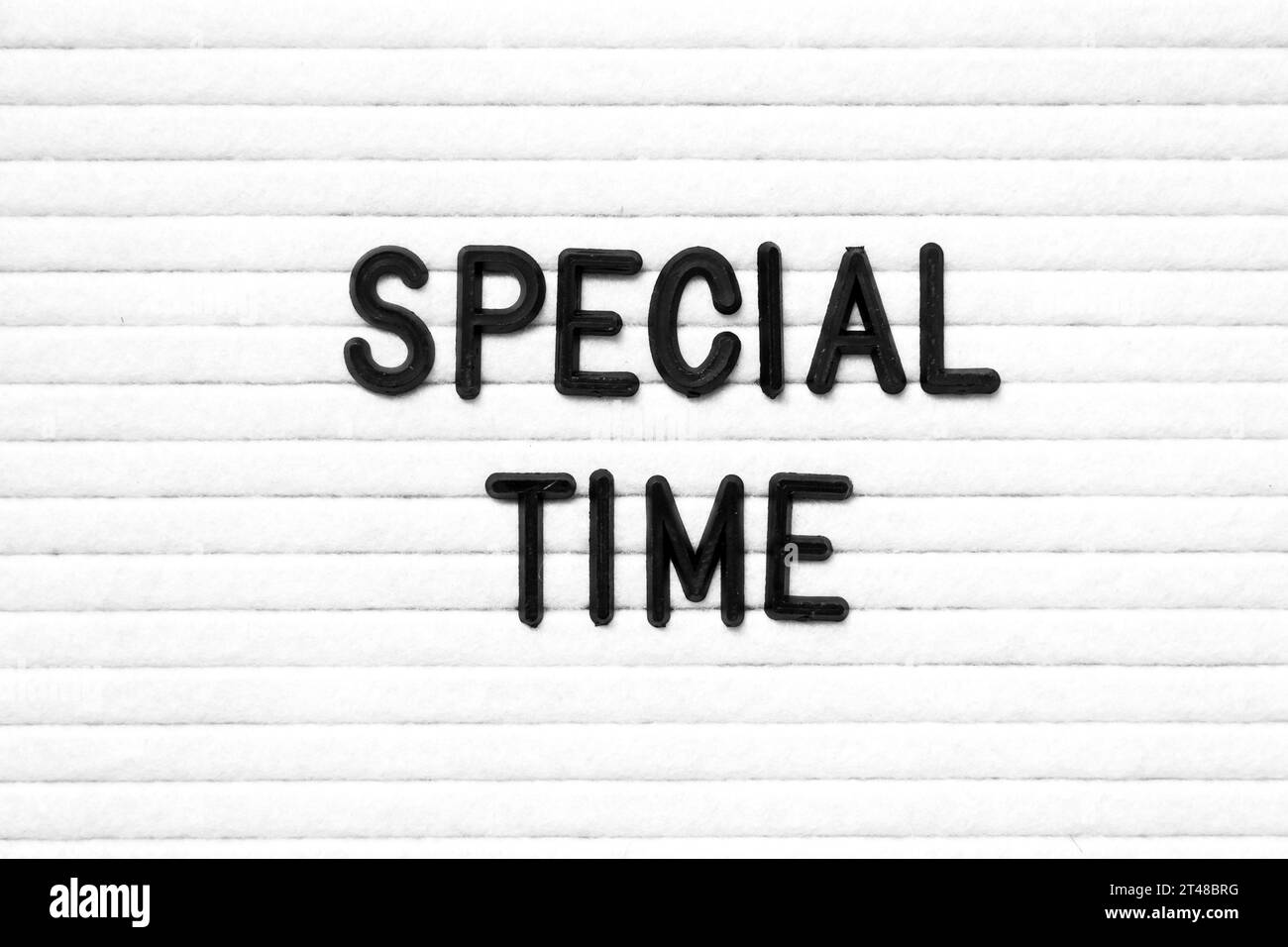 Black color letter in word special time on white felt board background ...