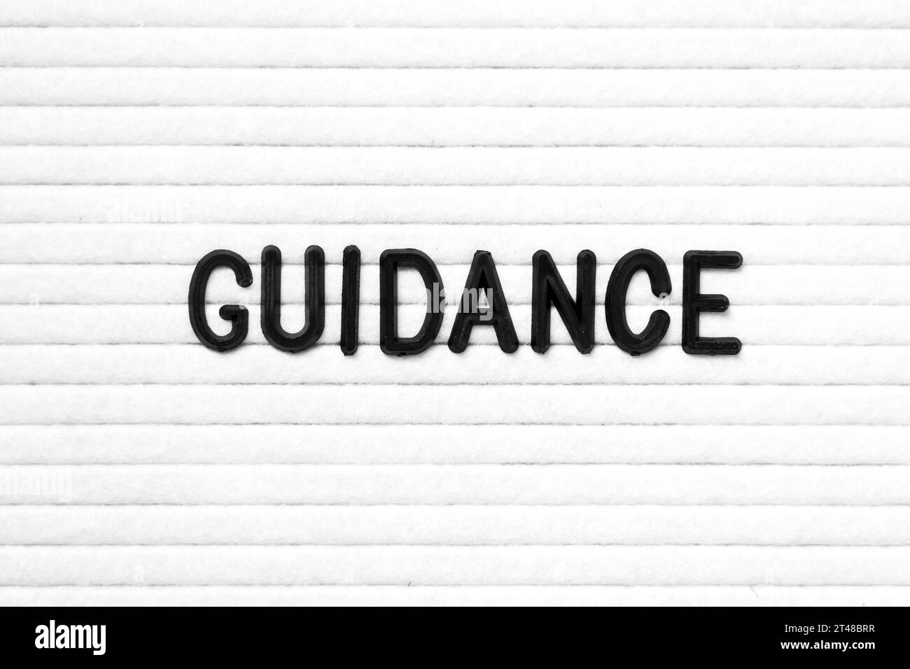 Black color letter in word guidance on white felt board background ...