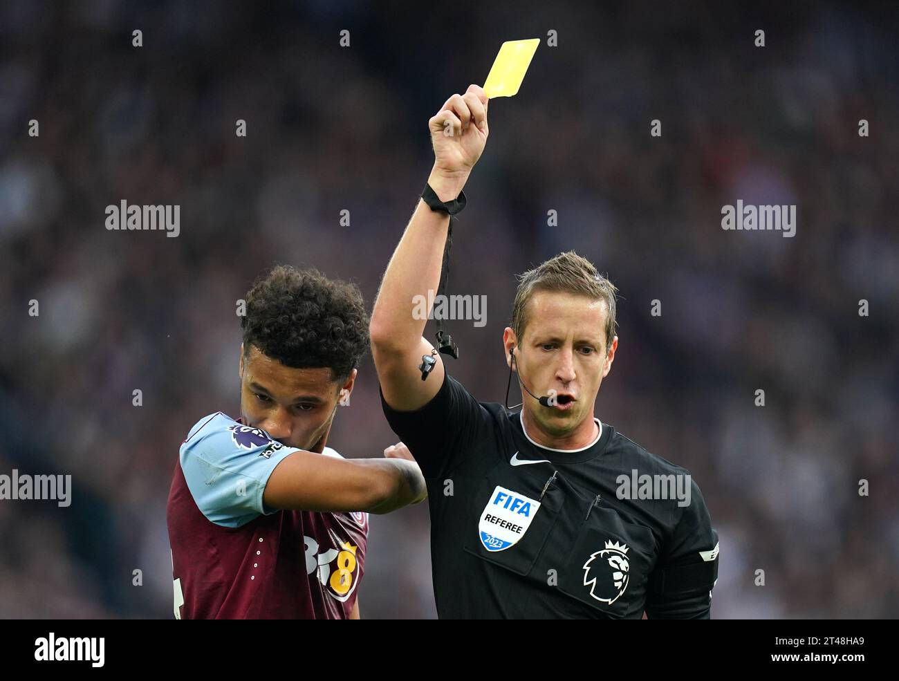 Referee John Brooks (right) shows a yellow card to Aston Villa's Boubacar Kamara during the ...