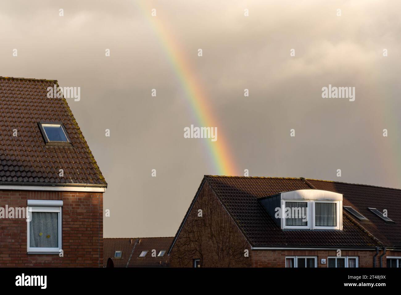 rainbow over the roof of a house Stock Photo - Alamy