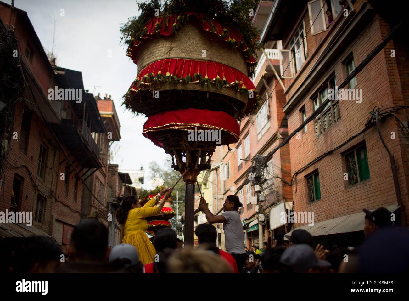 Kathmandu, Nepal. 29th Oct, 2023. People carry and rotate a traditional ...