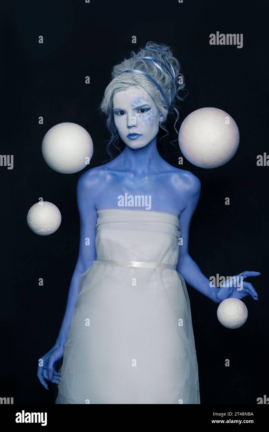 Beautiful model woman with stage makeup and hairstyle standing with ...