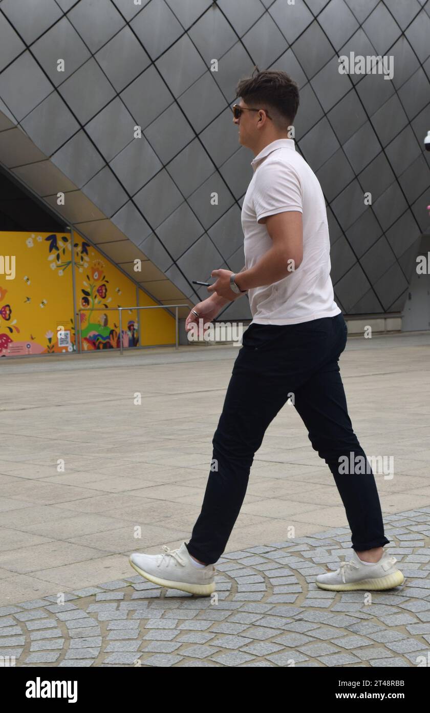 Man walking with phone in hand hi-res stock photography and images - Alamy
