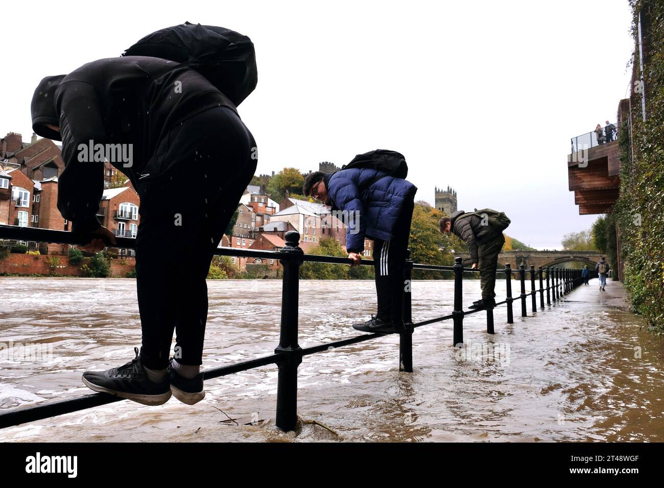A group of young boys hangs on railings as the River Wear burst its ...