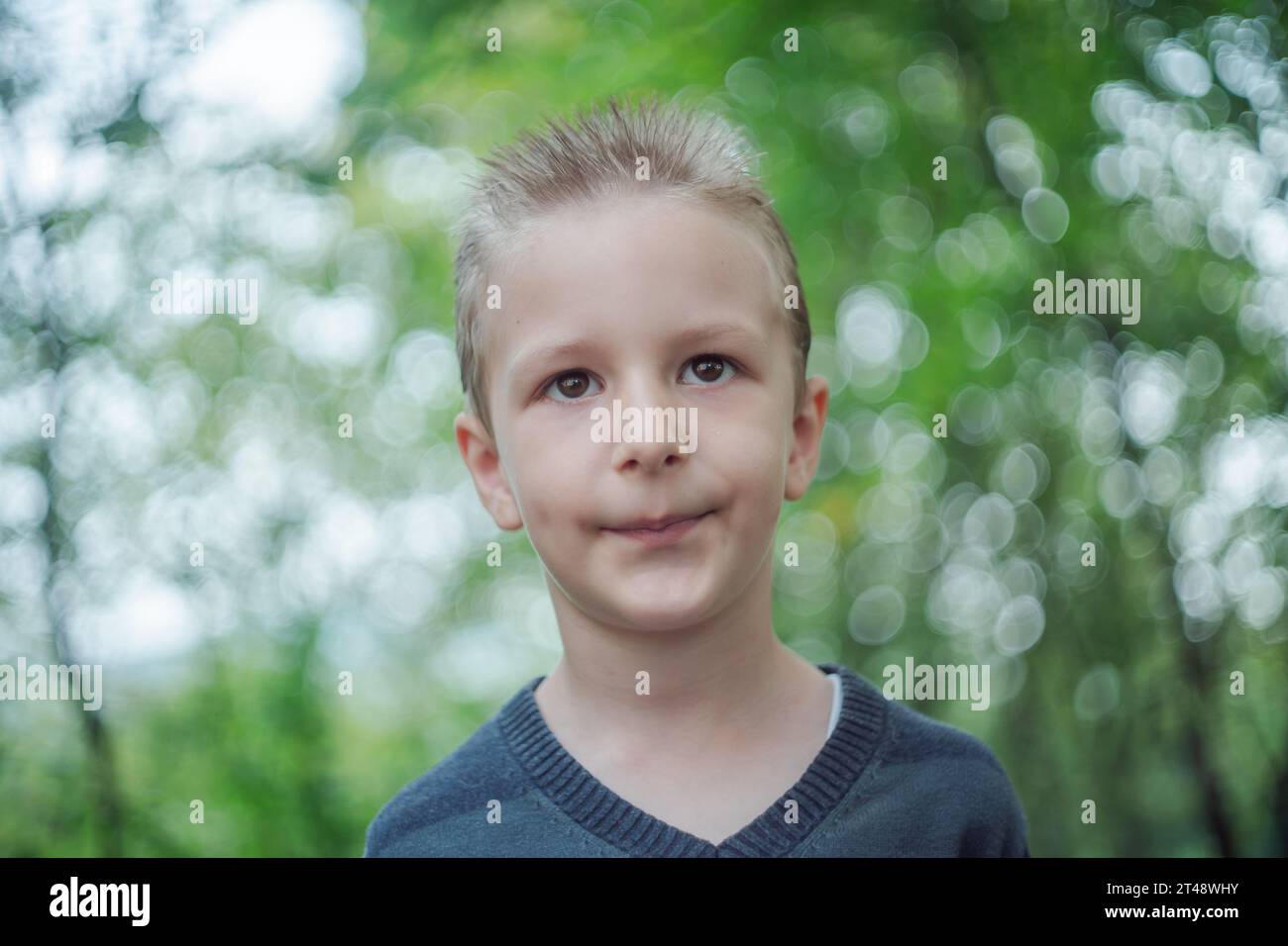 Cute little curious boy in green nature waiting for magic. Inquisitive ...