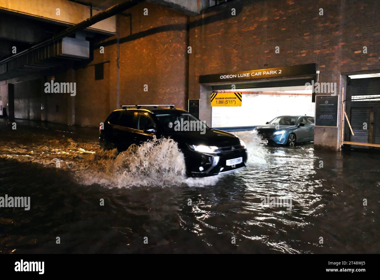 Cars pass through flood water as the River Wear burst its banks and ...