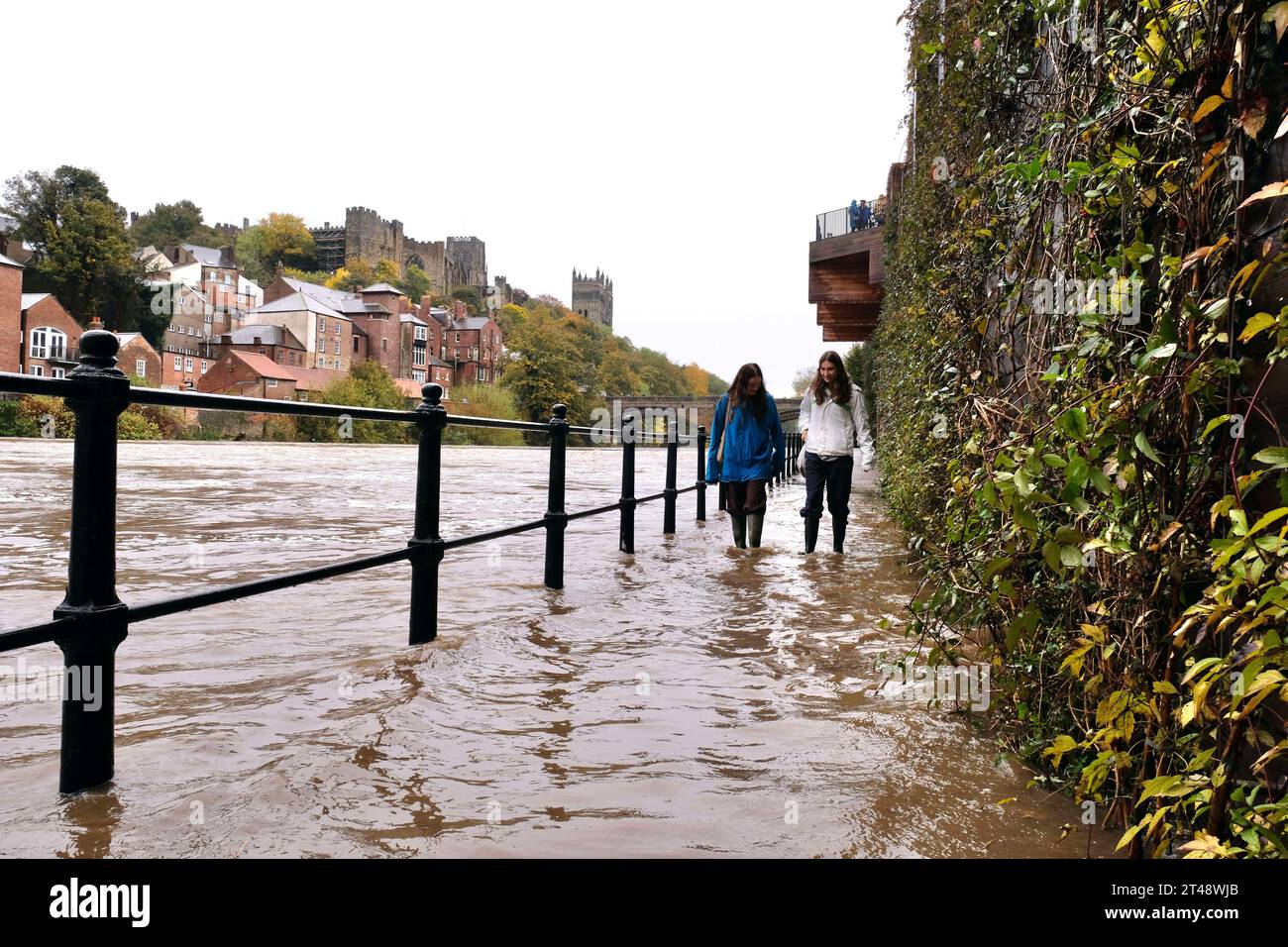 People walk through flood water as the River Wear burst its banks and ...