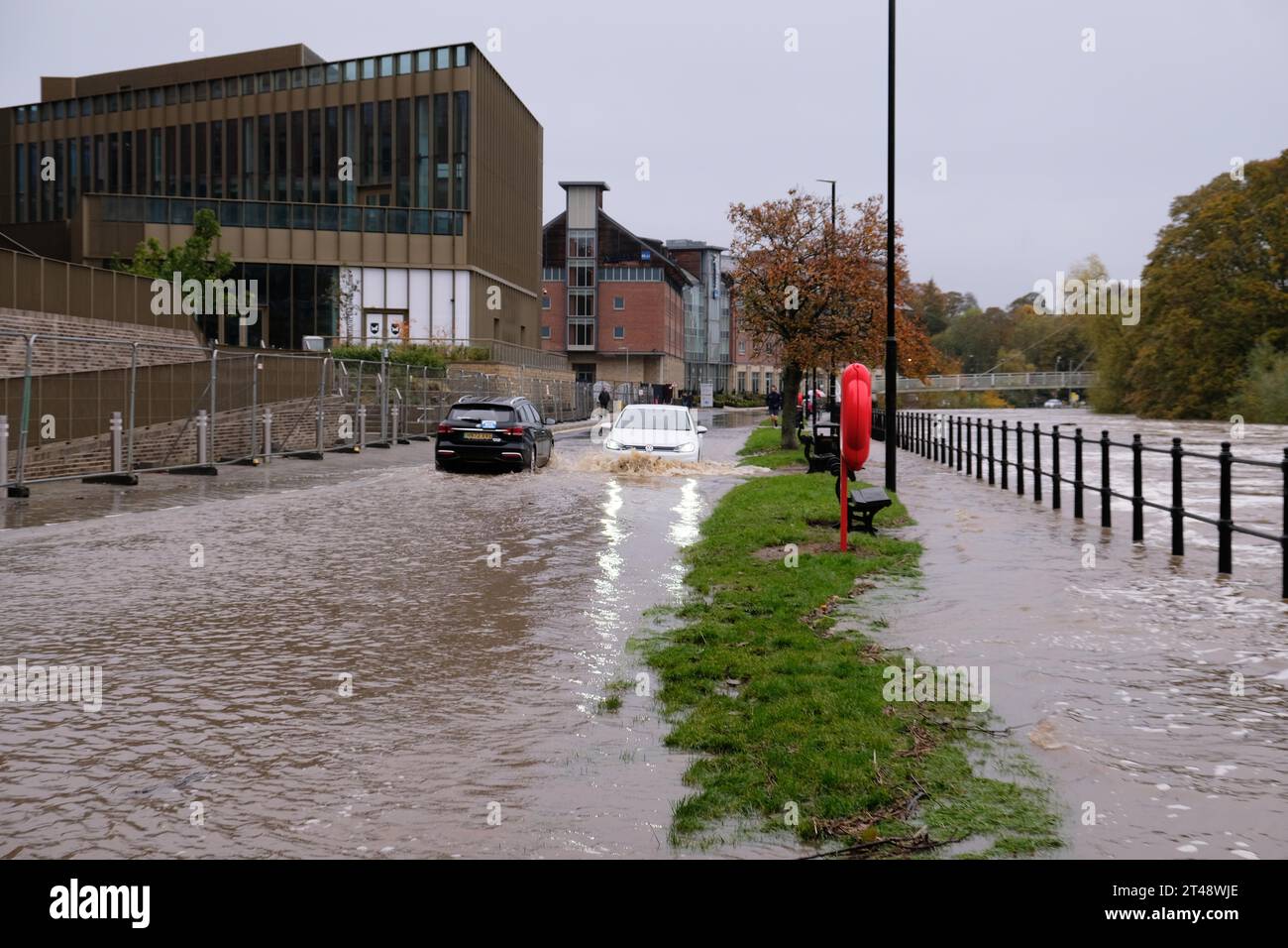 Cars pass through flood water as the River Wear burst its banks and ...