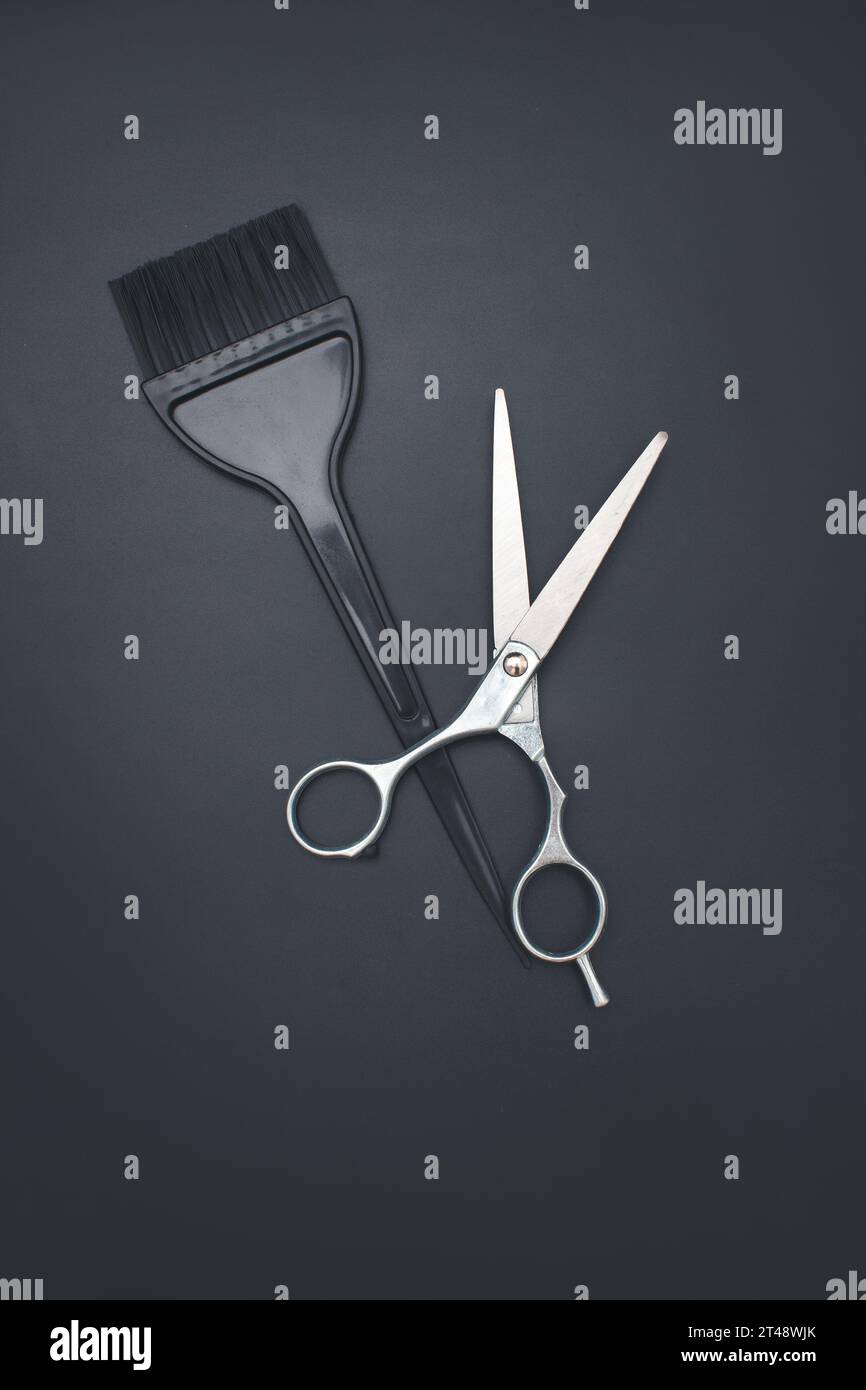 Hairdressing scissors and comb on black background. Stylish ...