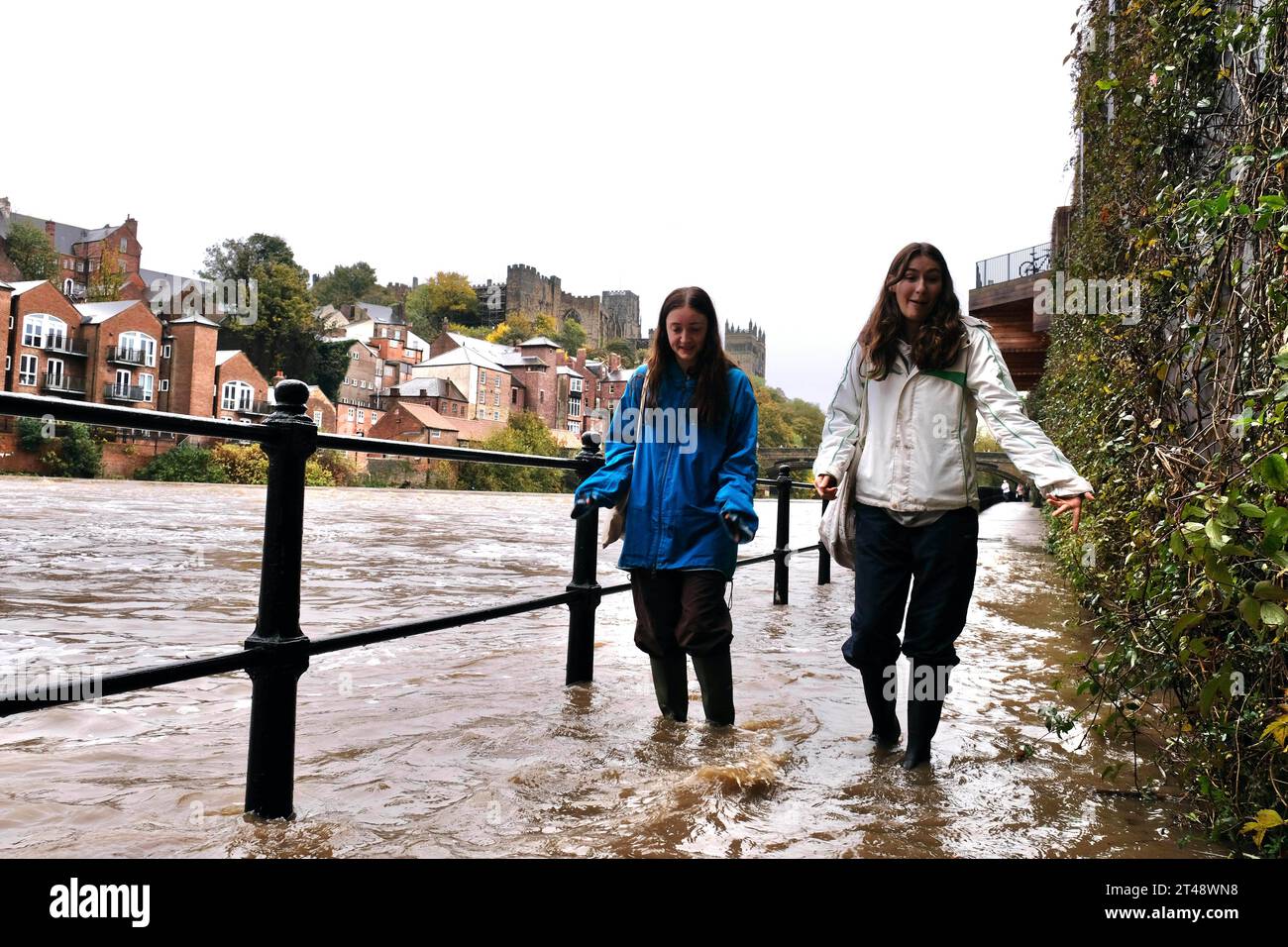 People walk through flood water as the River Wear burst its banks and ...
