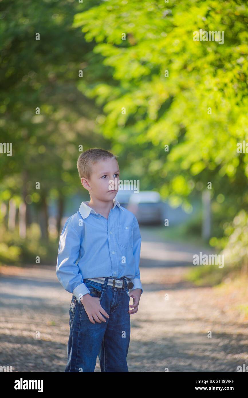 Cute little curious boy in green nature waiting for magic. Inquisitive ...