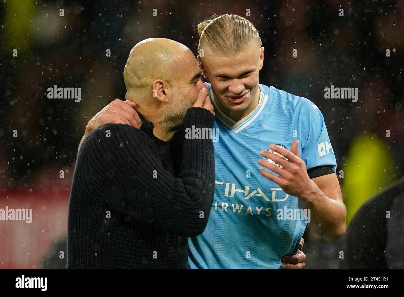 Manchester City's head coach Pep Guardiola talks to Manchester City's Erling Haaland after the ...