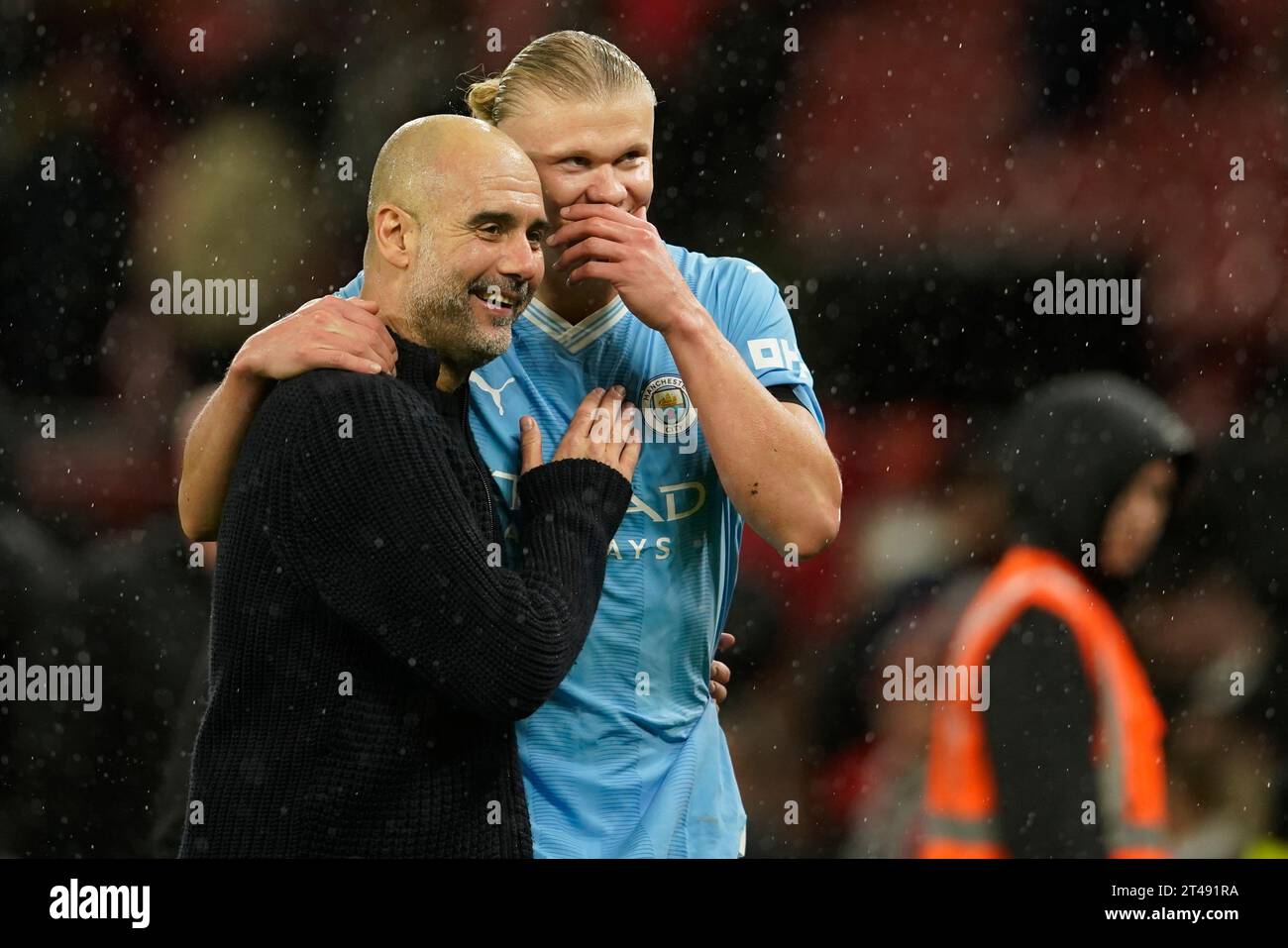 Manchester City's head coach Pep Guardiola talks to Manchester City's Erling Haaland after the ...